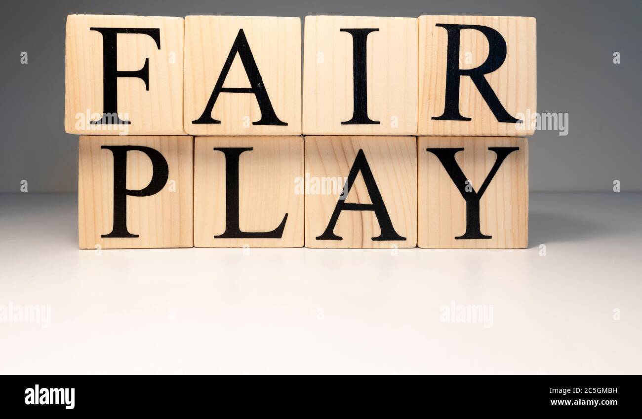 Fair play word from wooden cubes. Spotlight and white background Stock ...