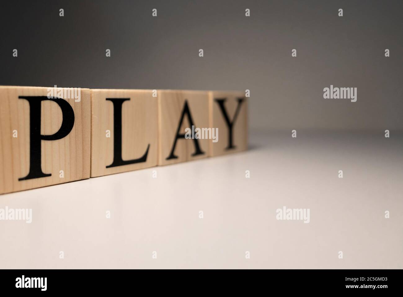 The word play from wooden cubes. Spot light and white background Stock ...