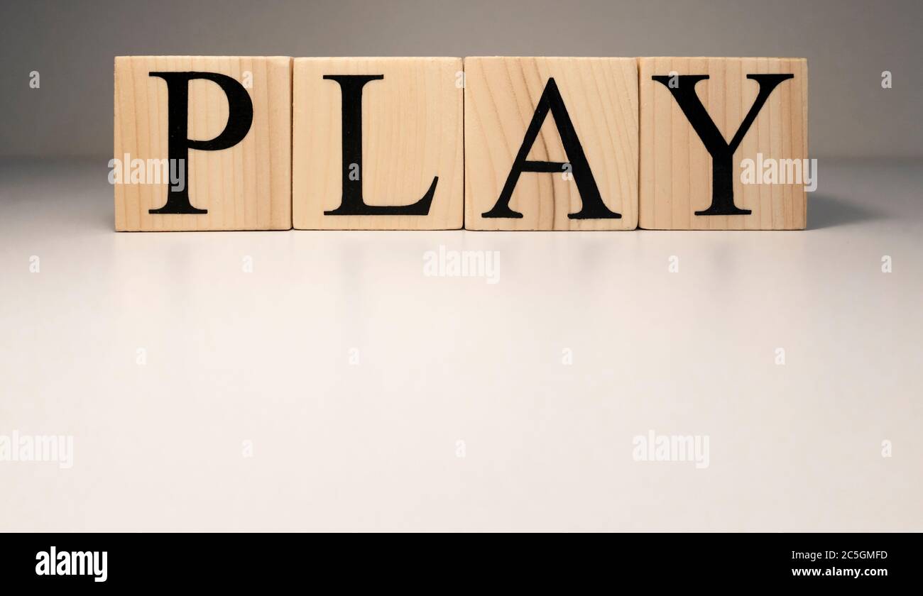 The word play from wooden cubes. Spot light and white background Stock ...