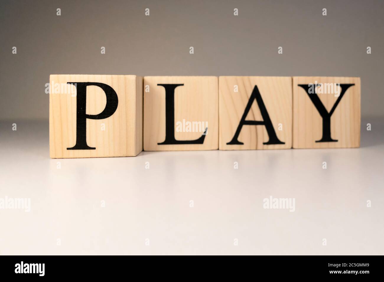 The word play from wooden cubes. Spot light and white background Stock ...