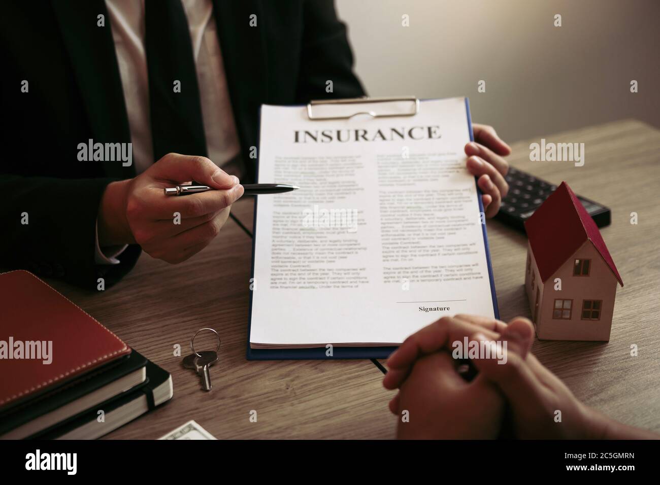 Agents are using pens pointing to insurance contracts and are being ...