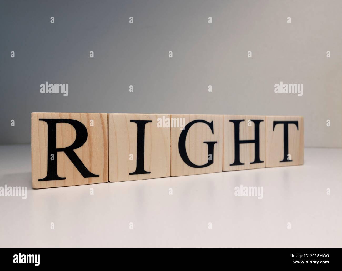 The word right from wooden cubes. Spot light and white background ...