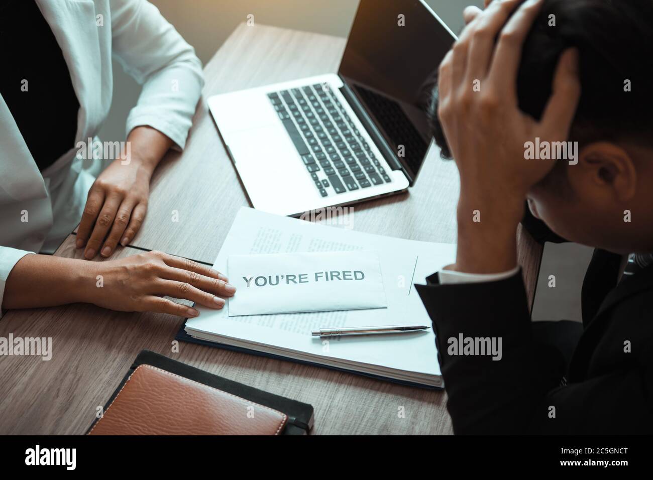 Female manager handed out a sack to the male employee while being ...