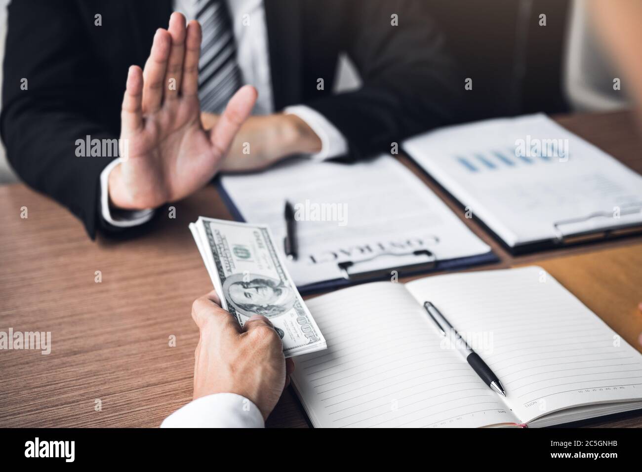 Business person refusing bribe given money by partner with anti bribery ...