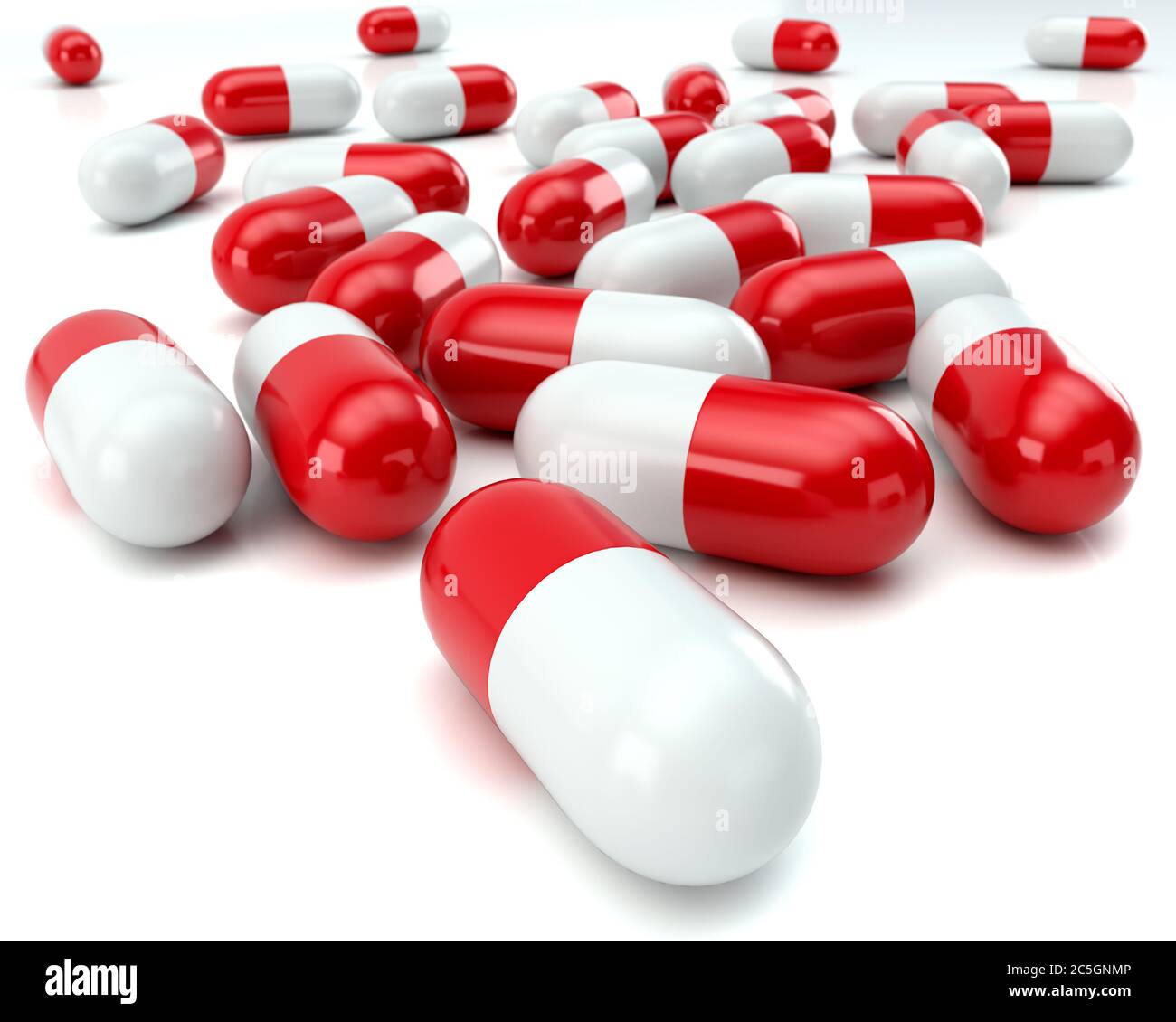 scattered red and white pills on white shiny background with depth of ...