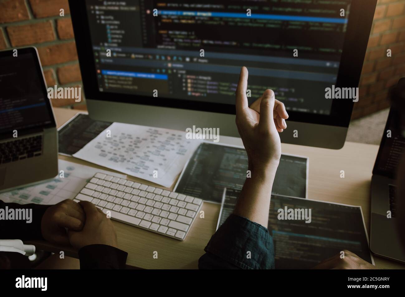 Two software developers are analyzing together about the code written ...