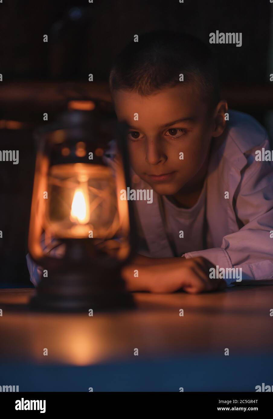 Lost child holding an old lamp in an apocalyptic environment Stock ...