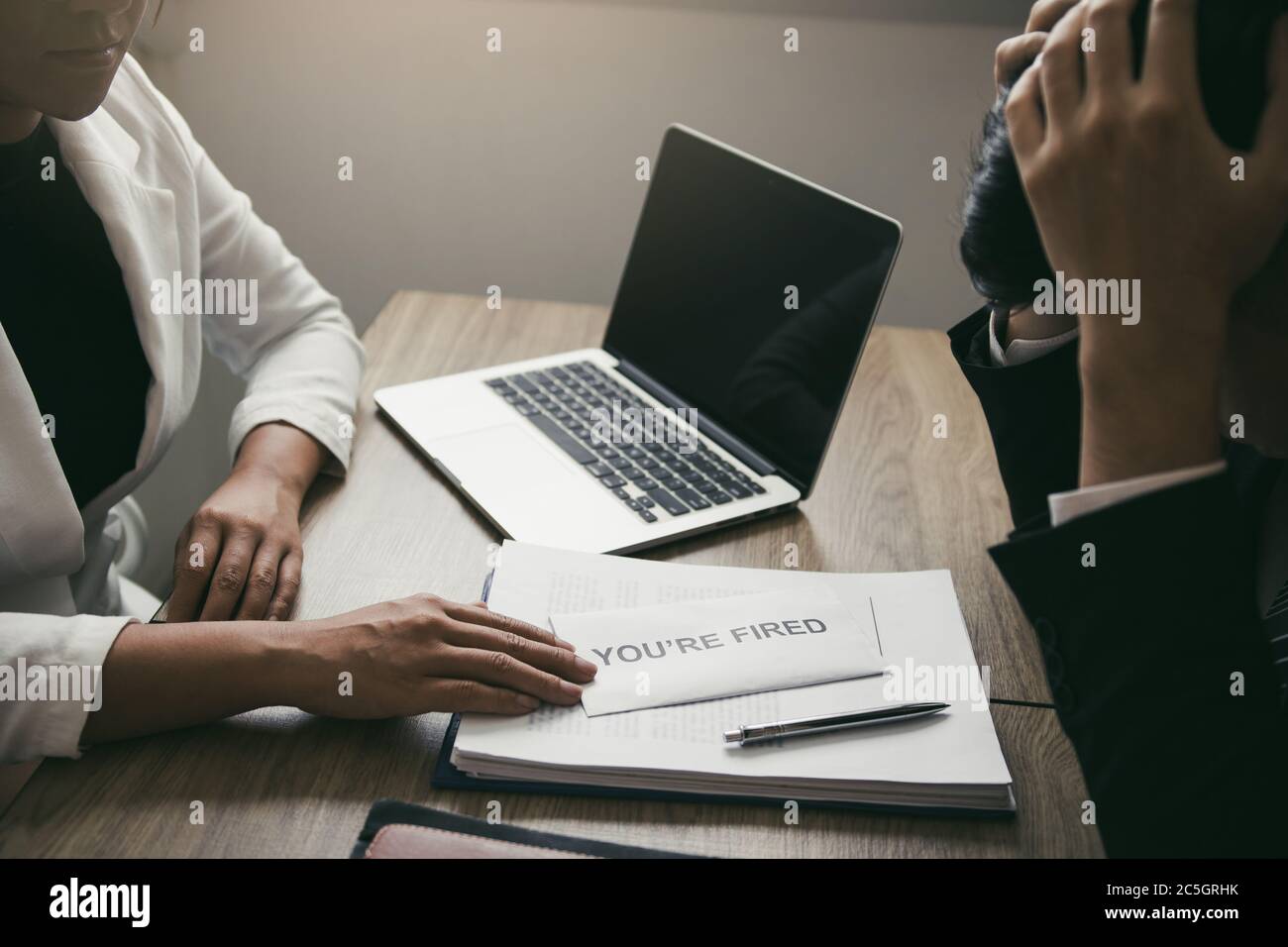 Female manager handed out a sack to the male employee while being ...