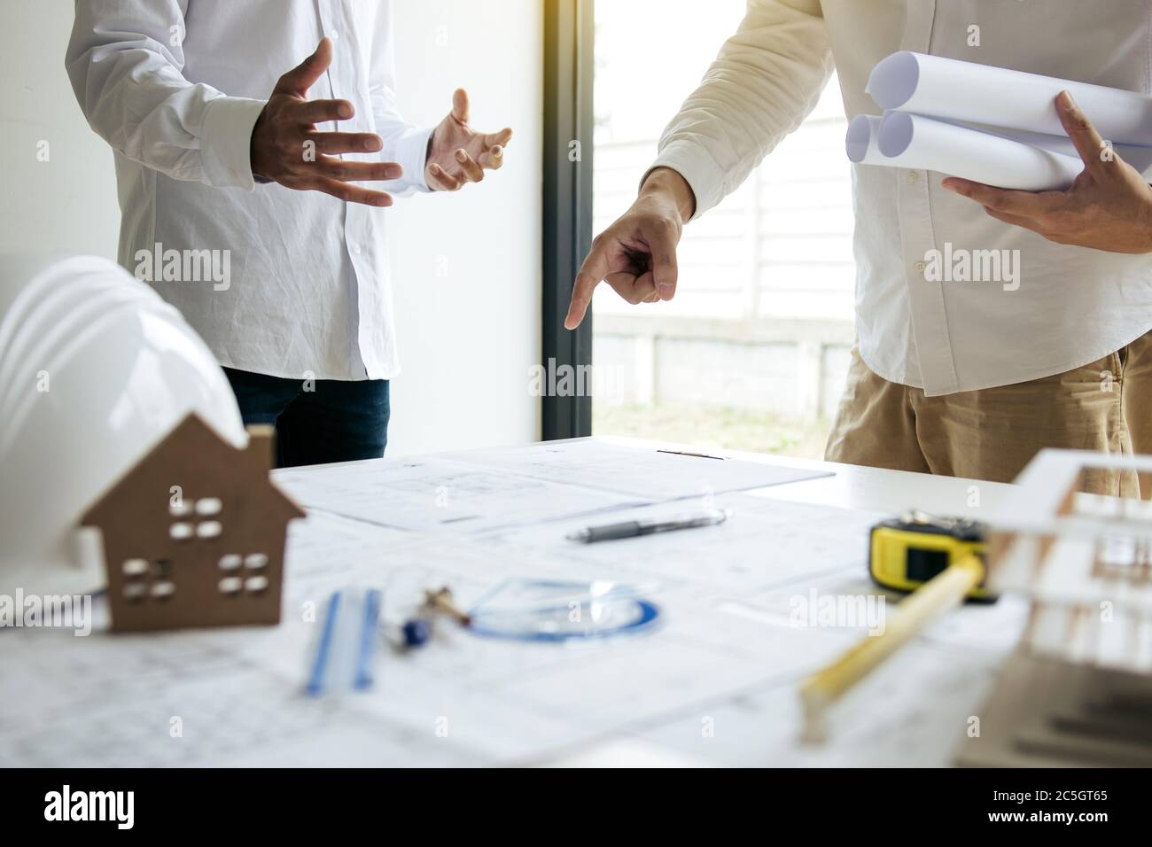 Team architect or engineering people standing working discussion ...