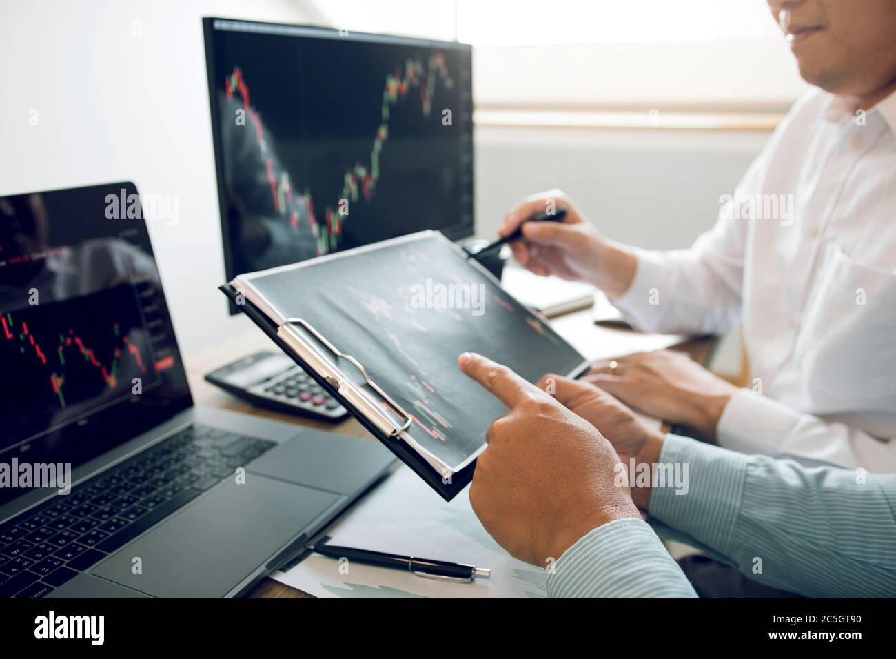 Team of agent trading business people pointing graph and analysis stock ...