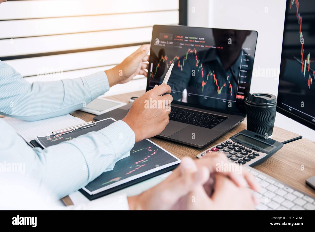 Two partnership investors discussion working together are analyzing the ...