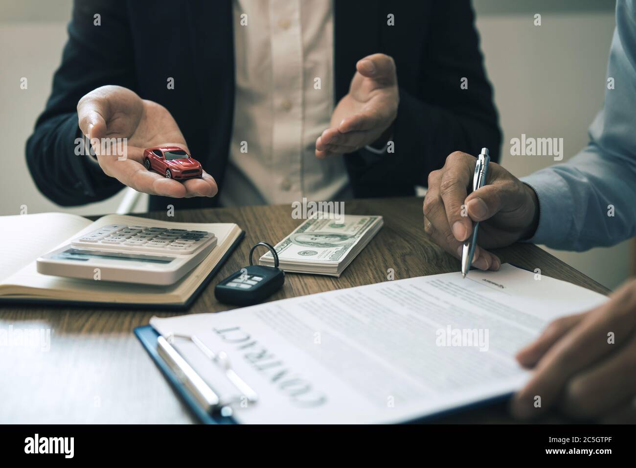 Sales car agent explains about the contract to buy a new car to the ...