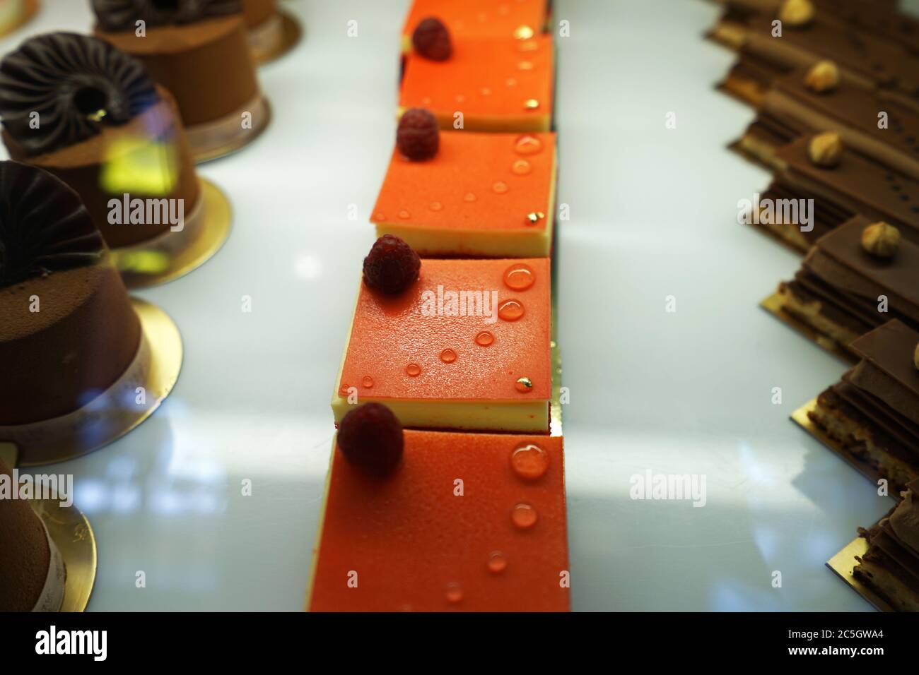 Assorted flavor colorful eclair and French pastry bakery displayed in ...