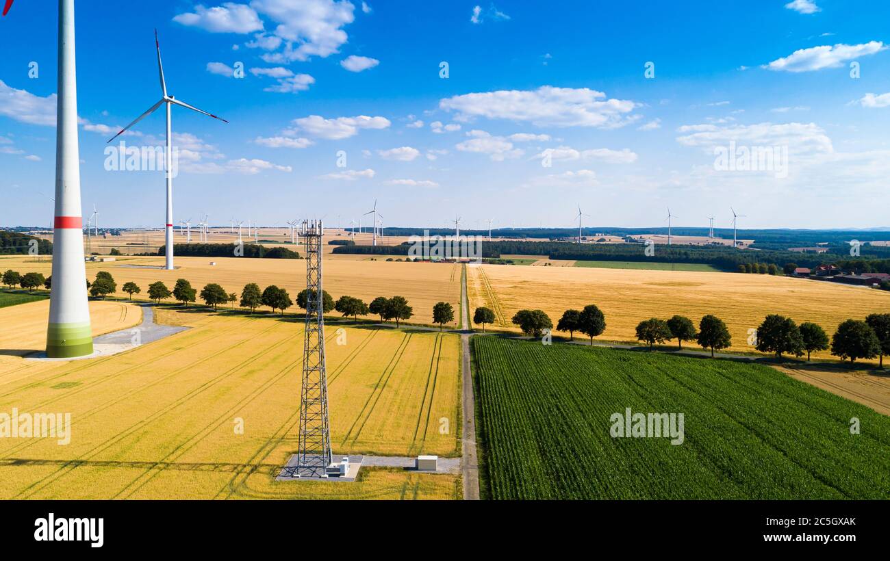 Aerial view of windmill against blue sky with clouds. Wind turbine farm ...