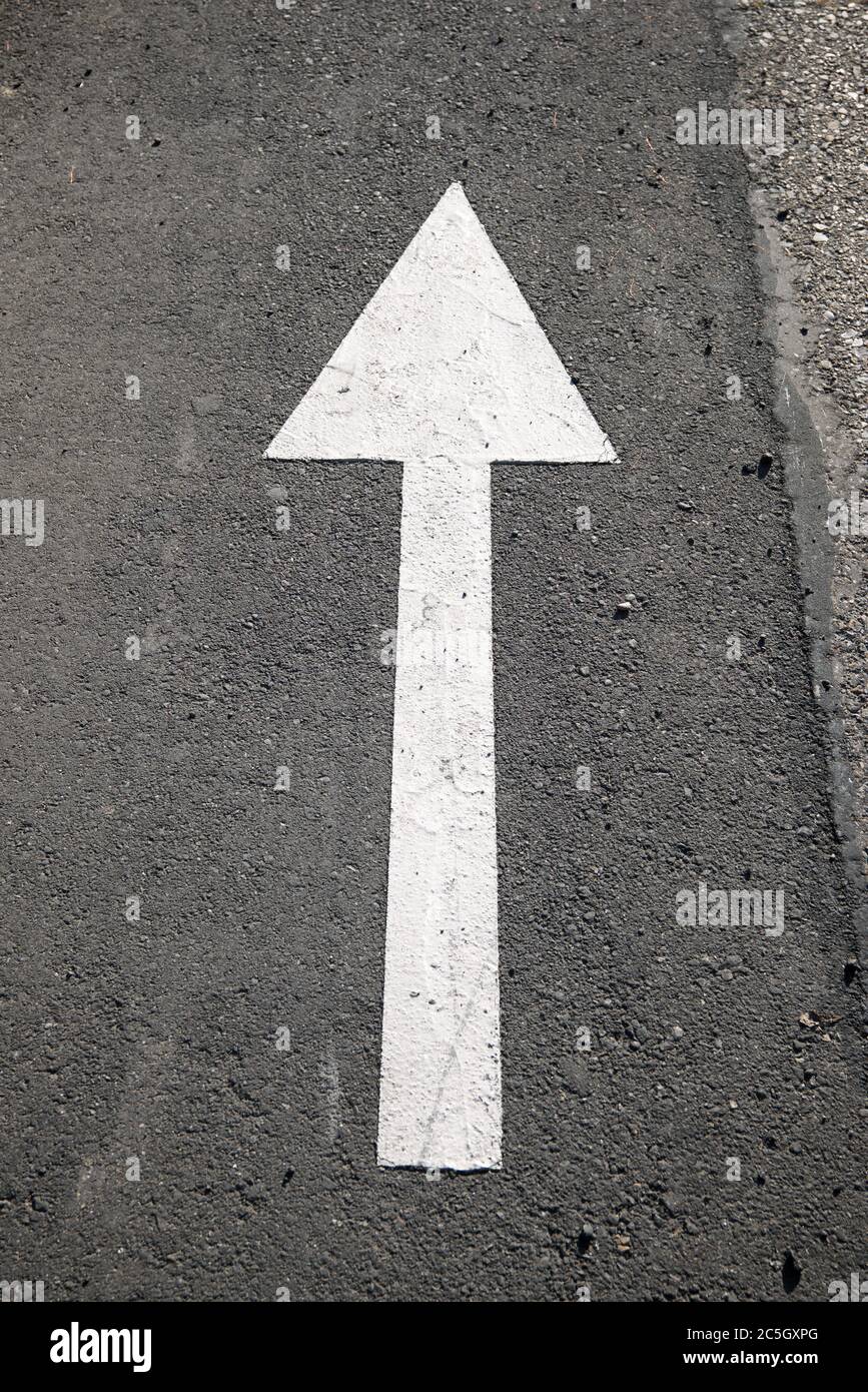 Single arrow directional sign on the floor Stock Photo - Alamy
