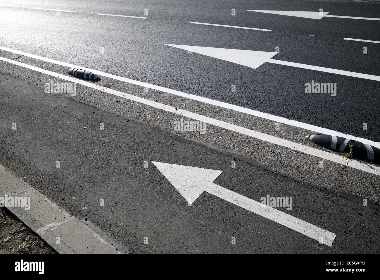 Two arrow directional signals on the floor Stock Photo - Alamy