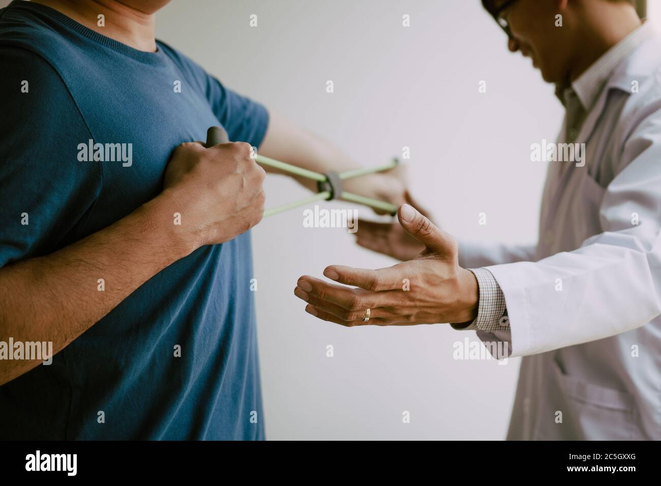 Asian male physical therapist descent working and helping to protect ...