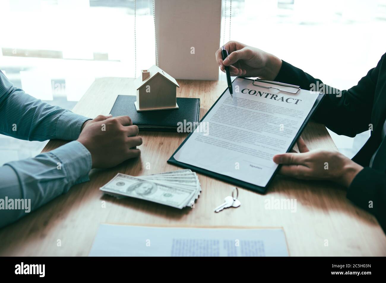 Agents are using pens pointing to insurance contracts and are being ...