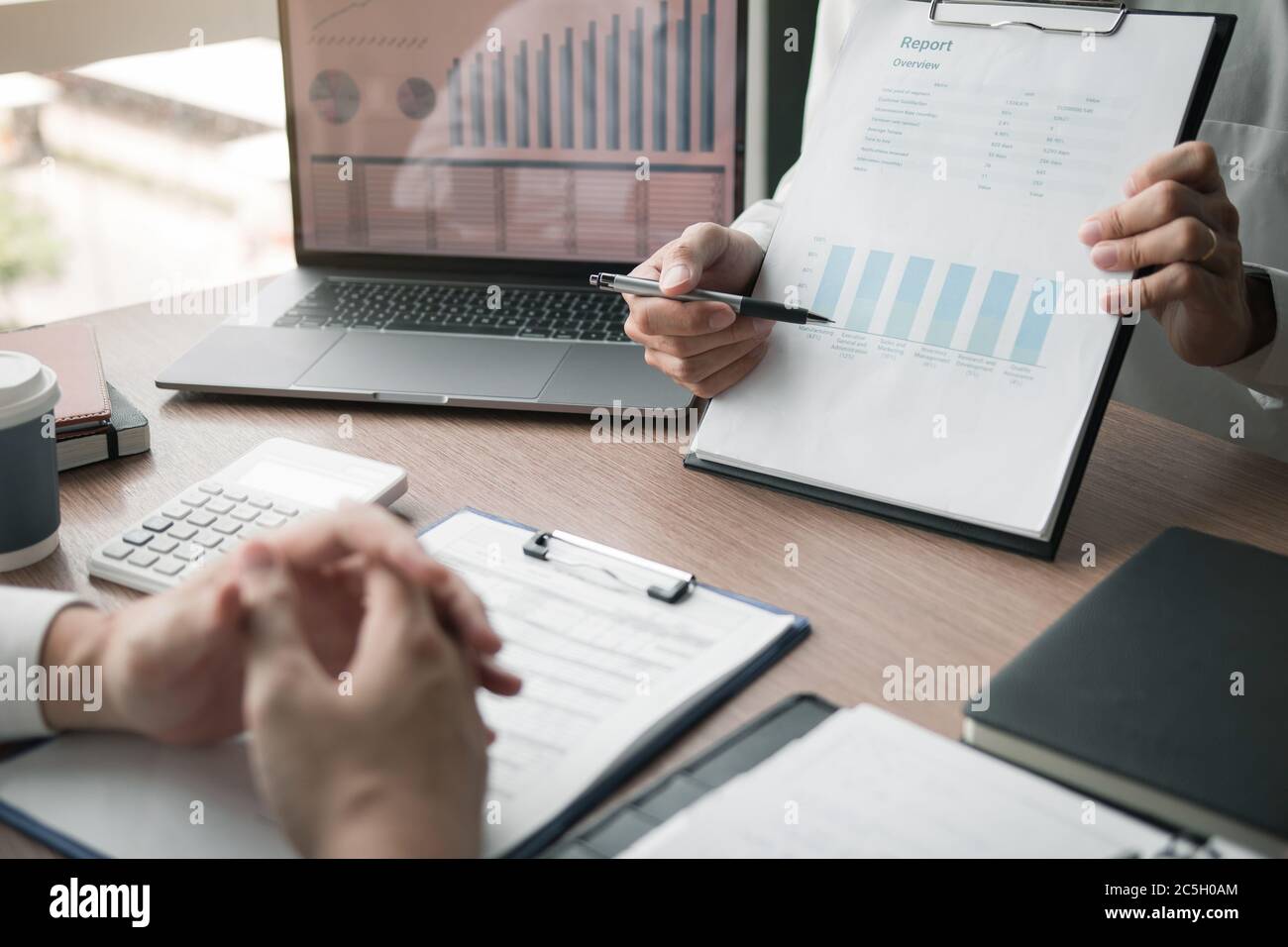 Business employee man are reporting about performance graphs summary ...