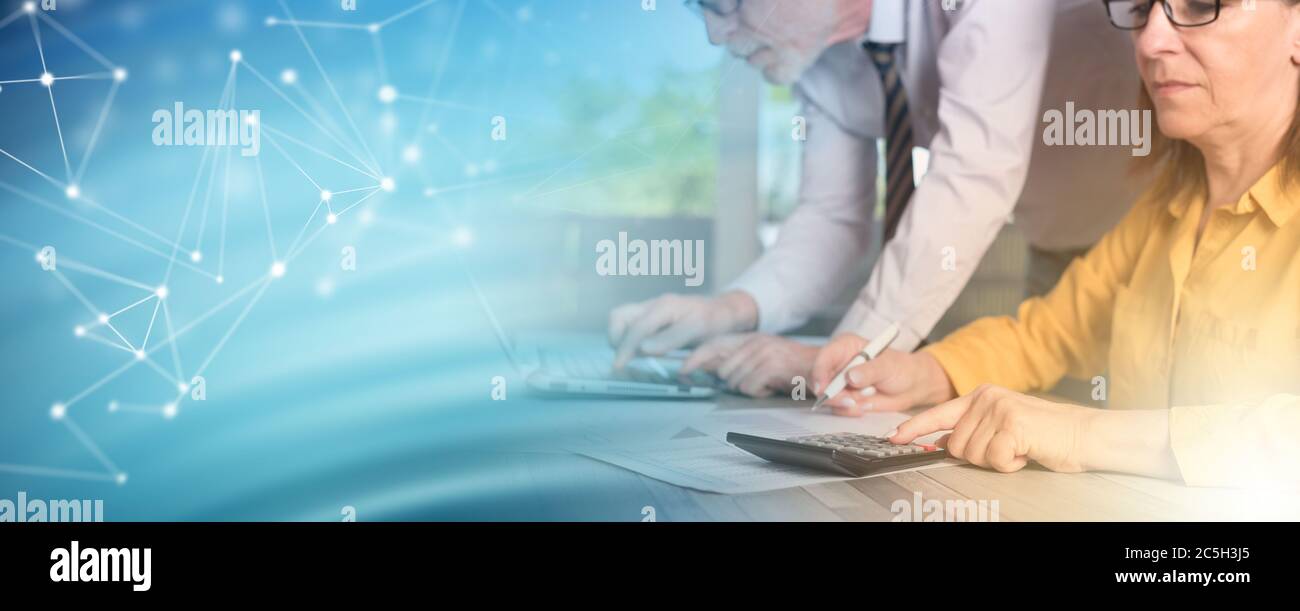 Two mature business people working together in office; panoramic banner ...