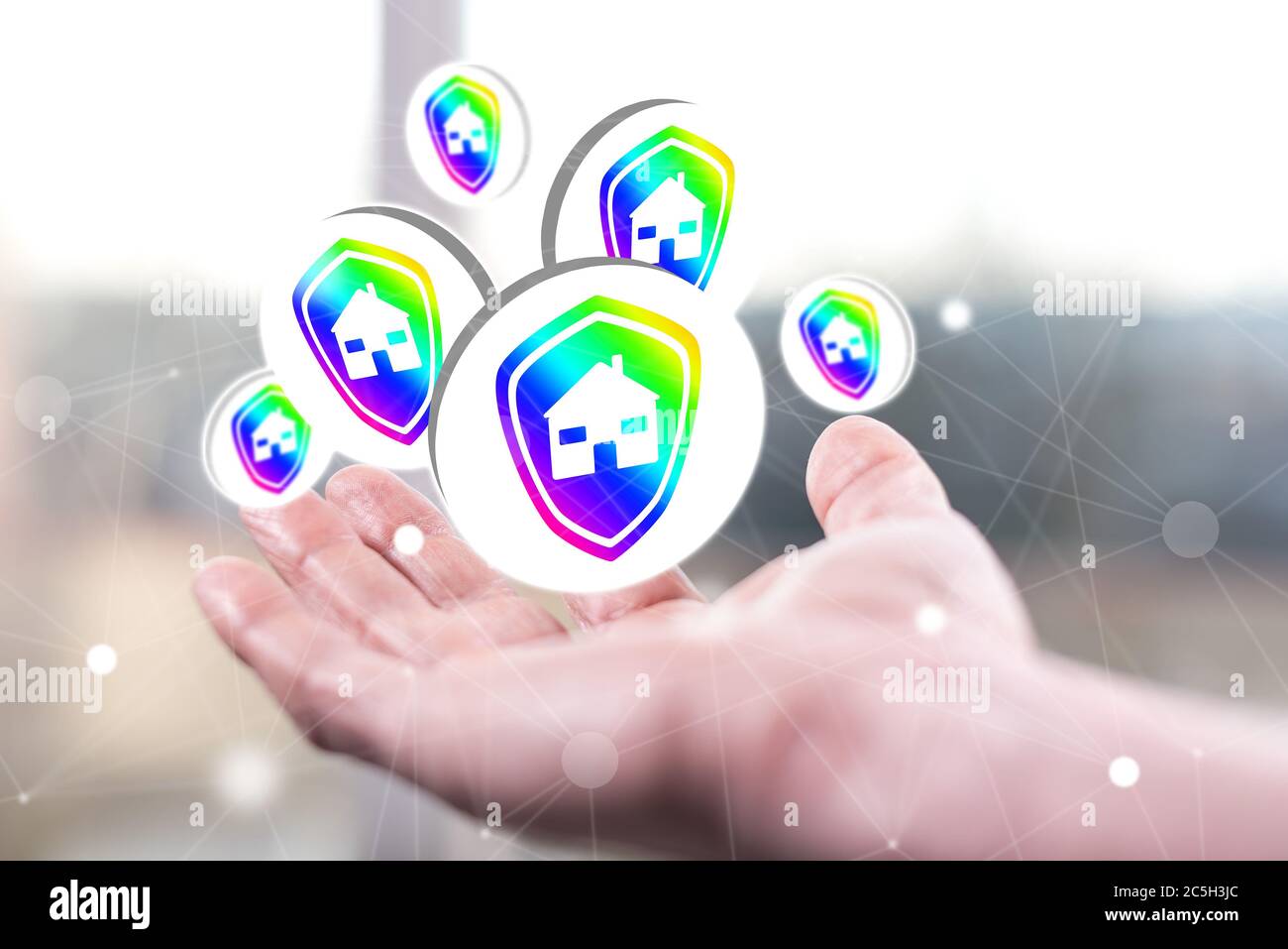 House protection concept above a hand of a man Stock Photo - Alamy