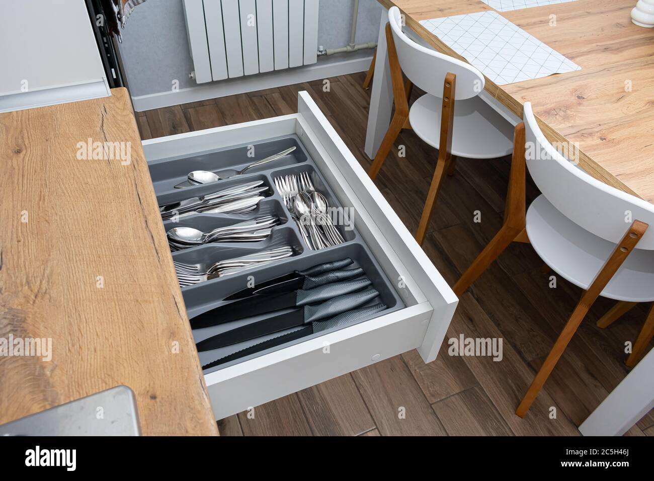 Stainless steel cutlery set in drawer. Opened kitchen drawer Stock ...