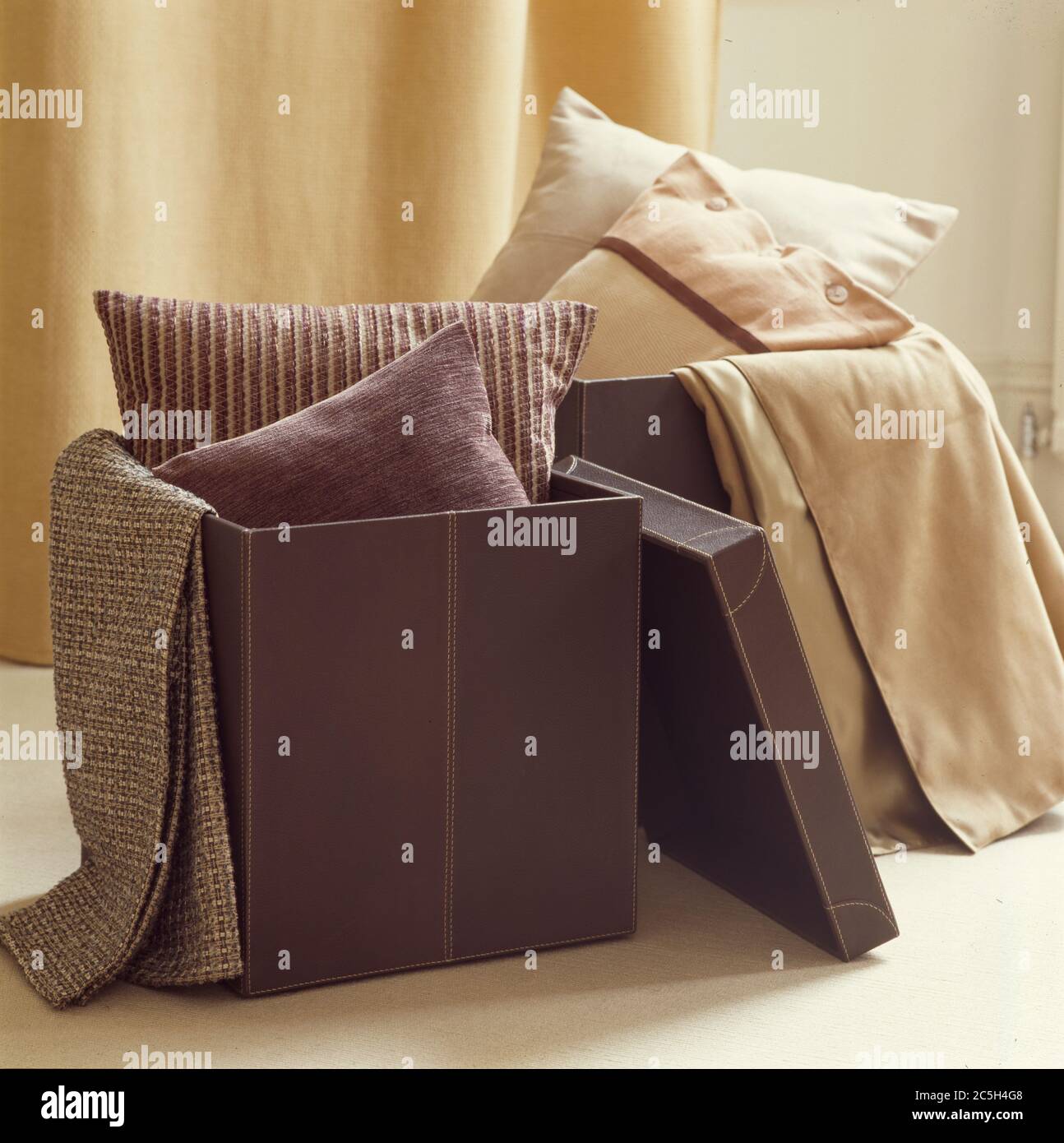 Brown storage boxes with browna and cream cushions and covers Stock ...