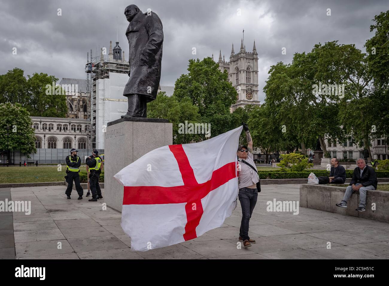 British nationalist supporters wave flags near the statue of Winston ...