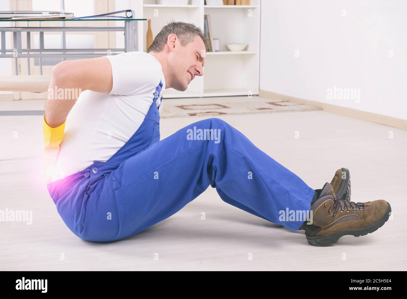 Man worker with back injury, concept of accident at work Stock Photo ...