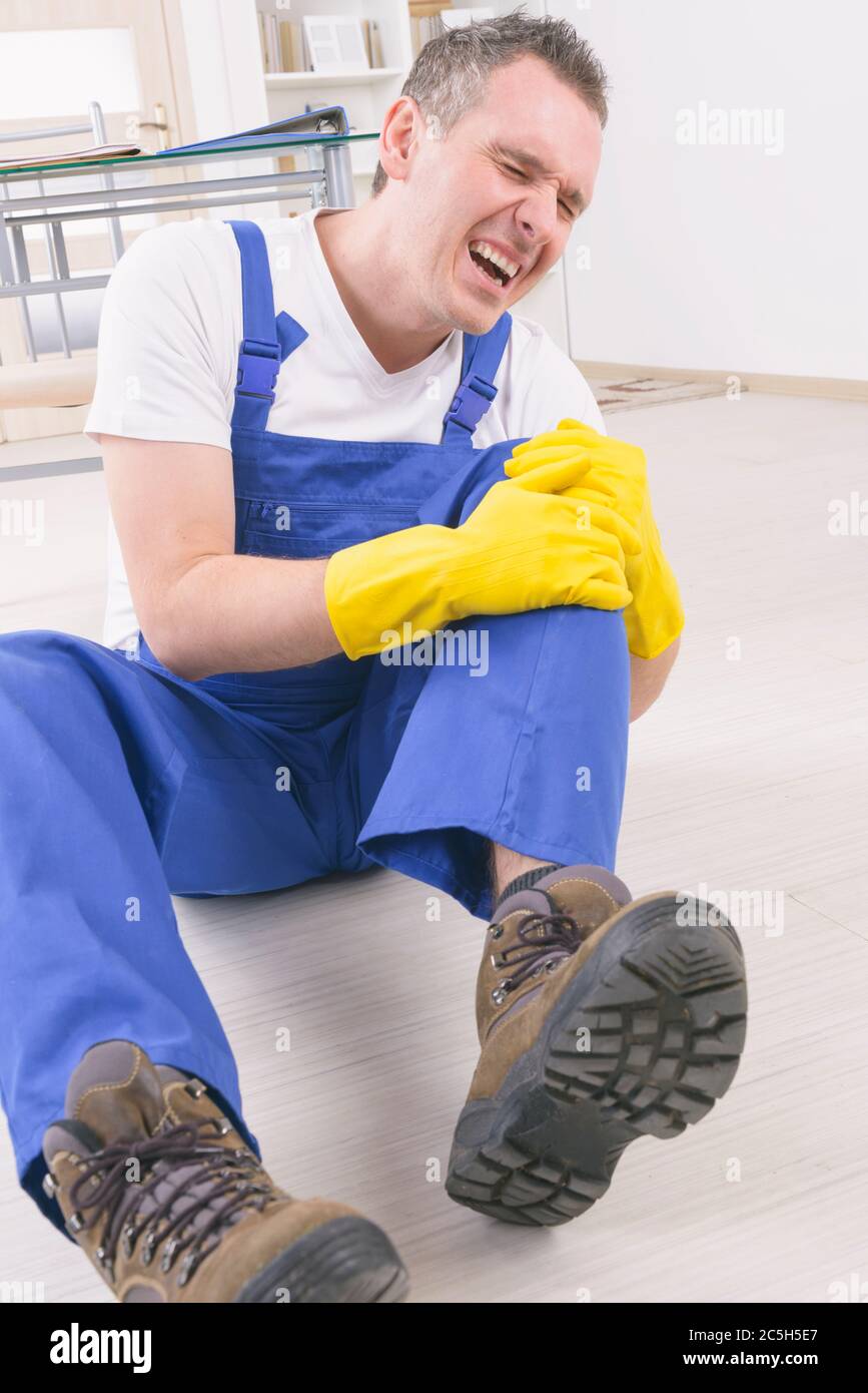 Man worker with knee injury, concept of accident at work Stock Photo ...