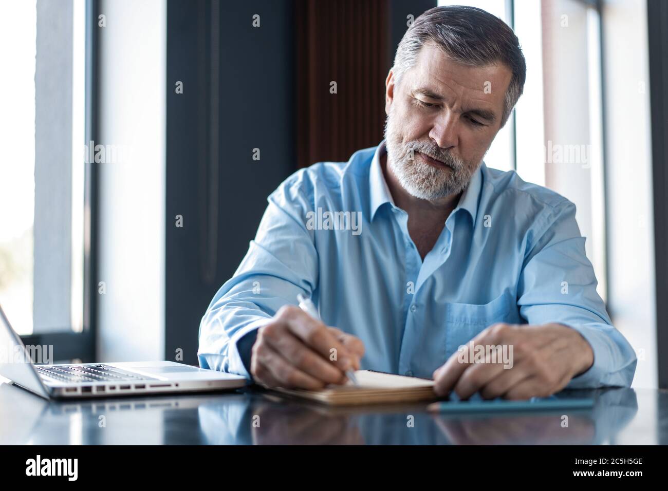 Serious businessman looking through documents hi-res stock photography ...