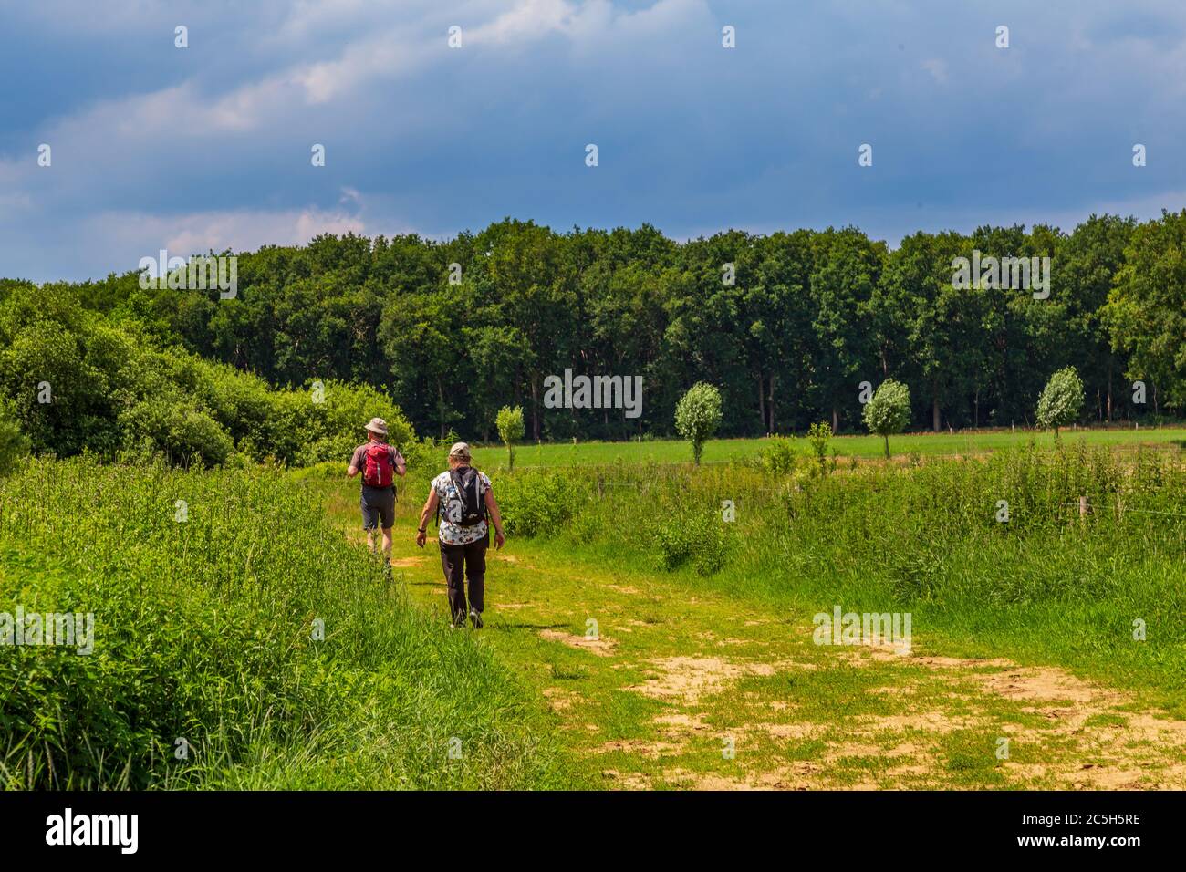 Two people walking through pathway hi-res stock photography and images ...
