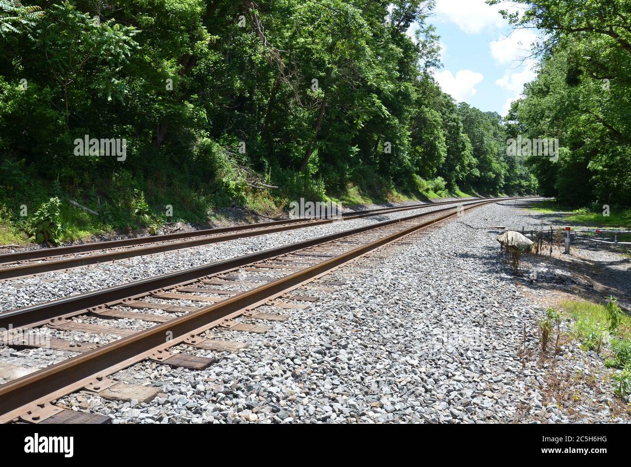 iron metal railroad train tracks with stones or rocks Stock Photo - Alamy