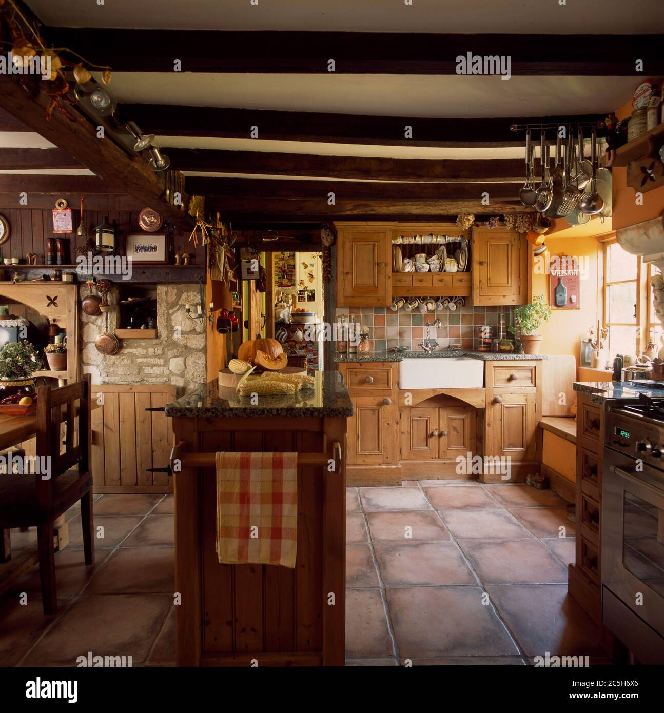 Cottage kitchen with tiled floor and pine units Stock Photo - Alamy