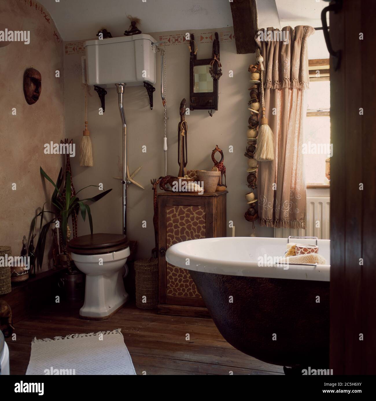 Bathroom with WC and traditional high level cistern and free standing ...