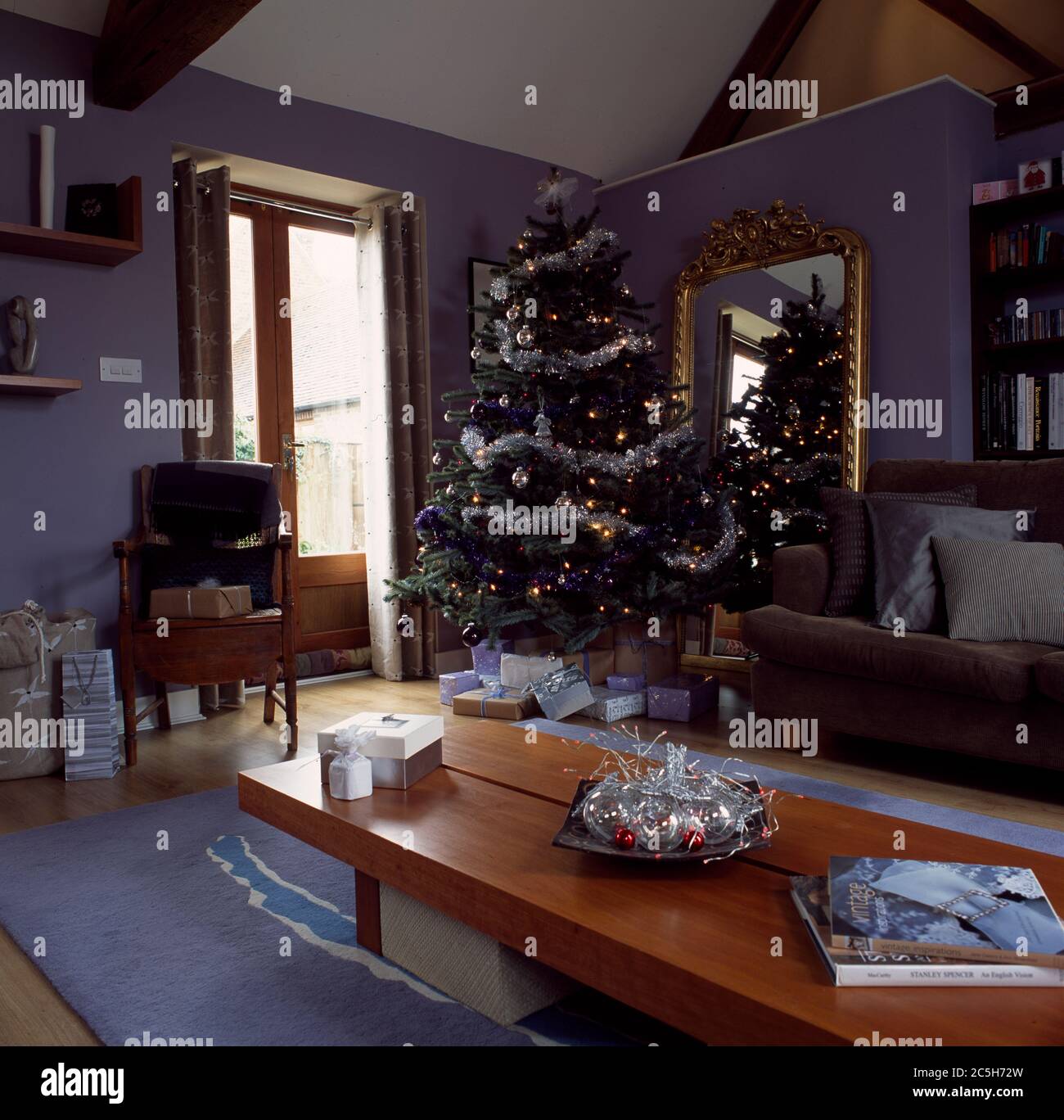 Christmas tree with lights in corner of livingroom Stock Photo - Alamy