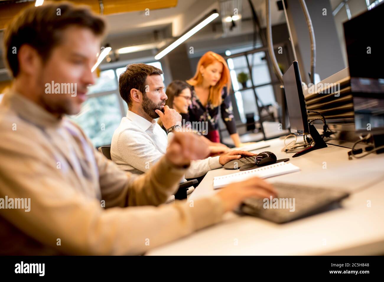 Handsome young professional businessman uses a computer for work in the ...