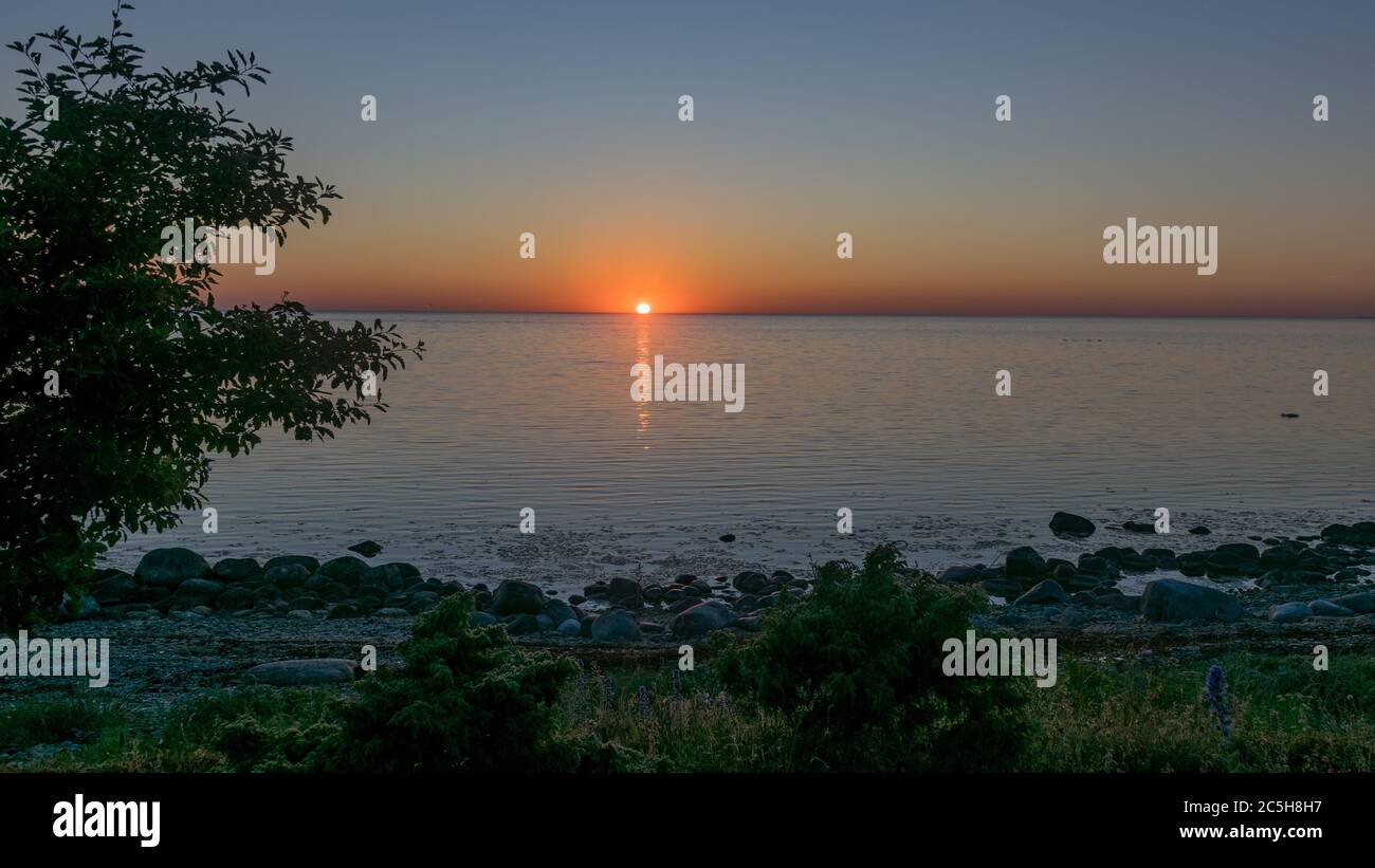 beautiful sunset landscape from a traditional rocky beach on the island ...