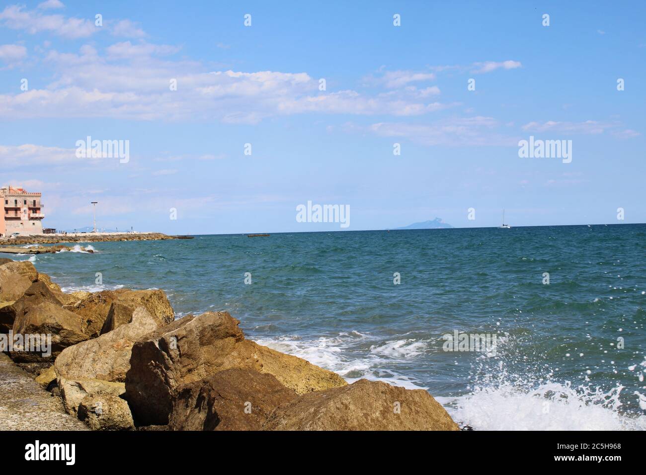 sea water splashes touching the stone on beach Stock Photo - Alamy