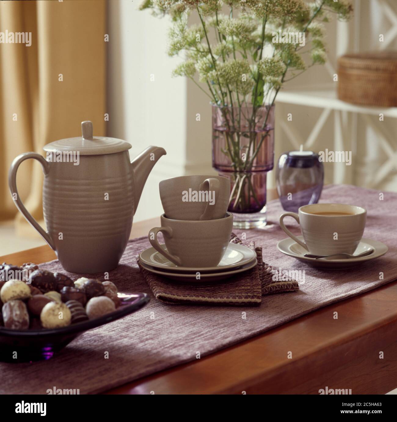 Coffee pot and cups on table Stock Photo - Alamy