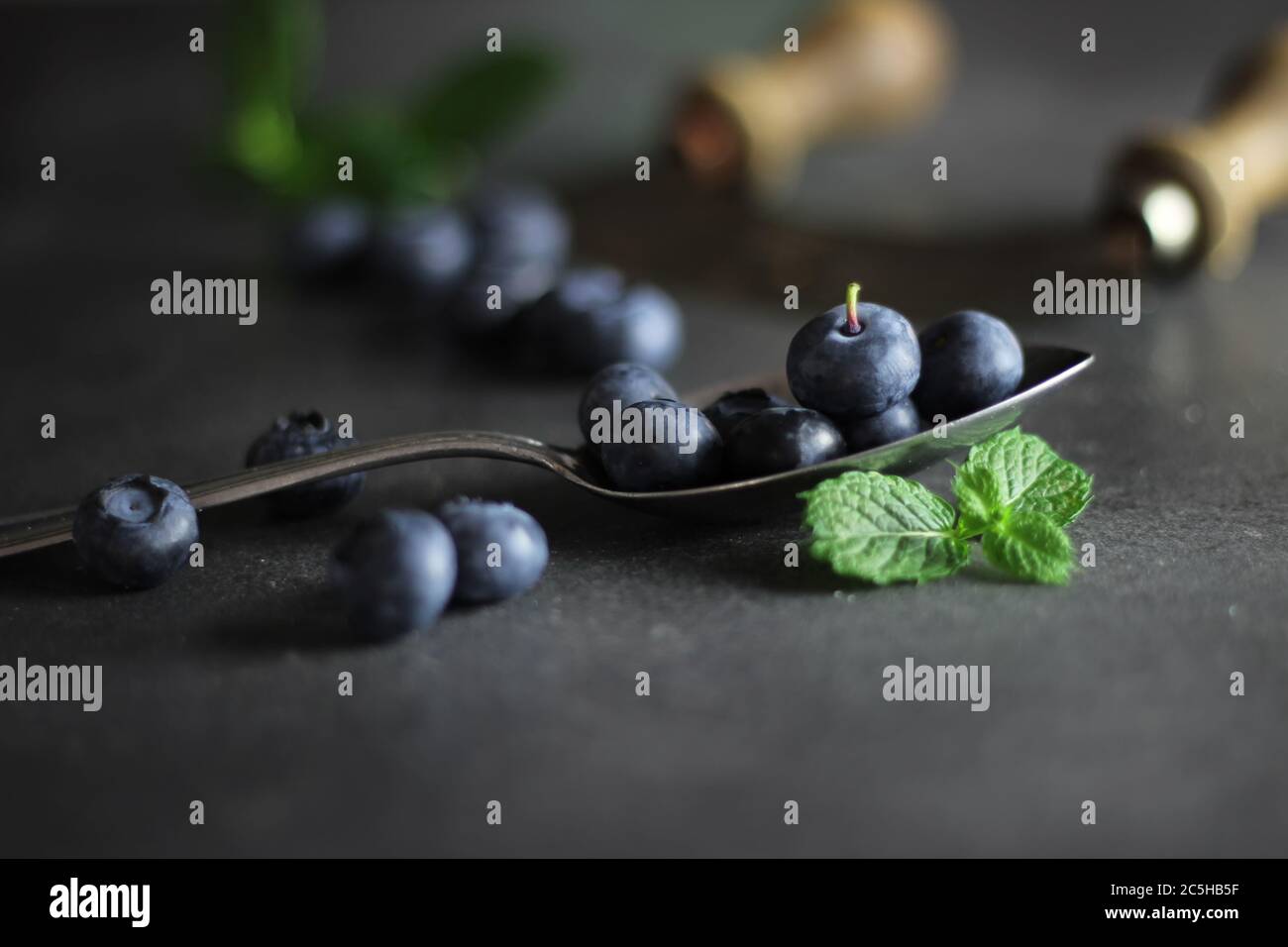 mystic light blueberries on dark background Stock Photo - Alamy