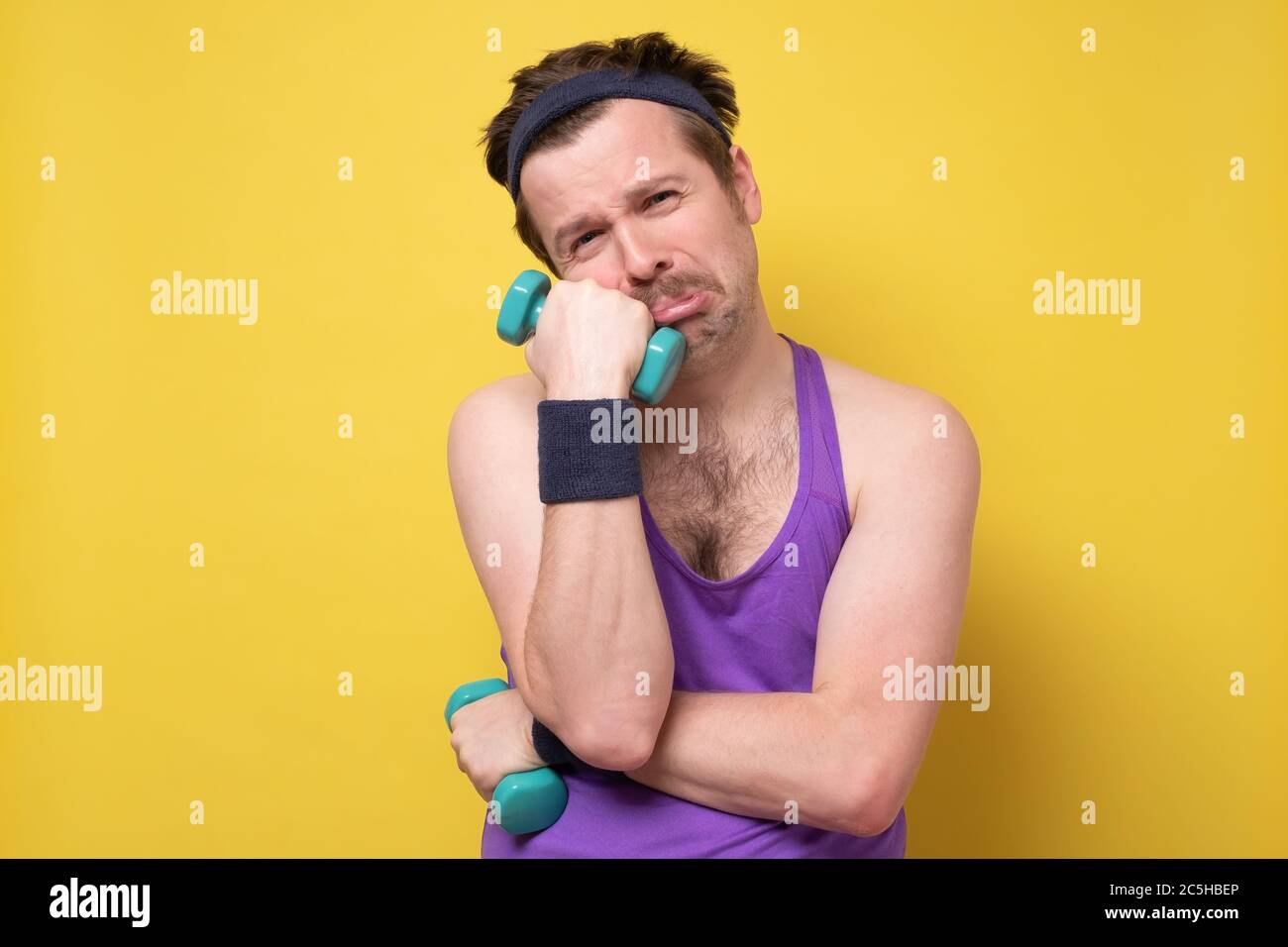 Sad man with a dumbbell being tired after training Stock Photo - Alamy