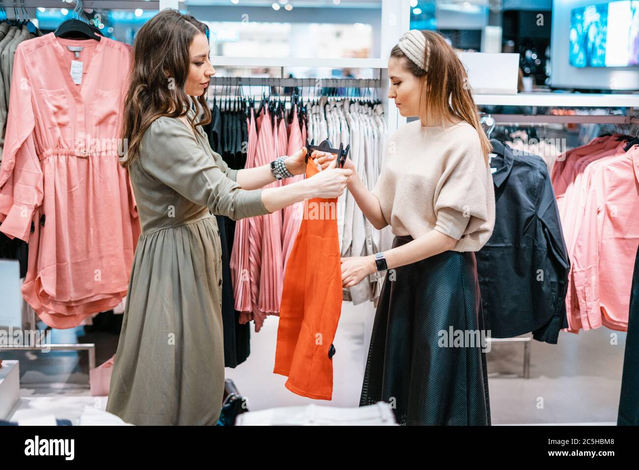 Trade, buyers. Two beautiful girls make purchases in a shopping center ...