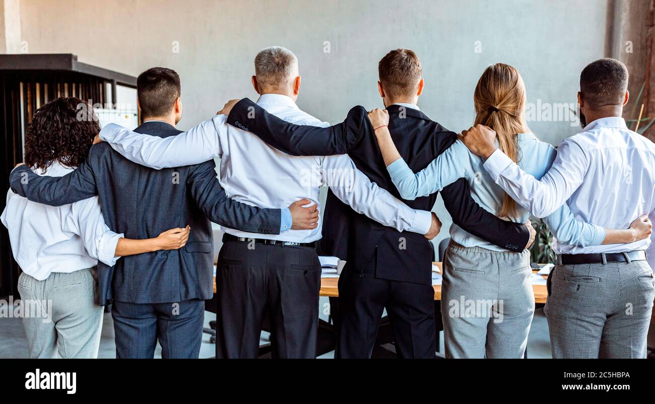 Team office collaboration embracing hi-res stock photography and images ...