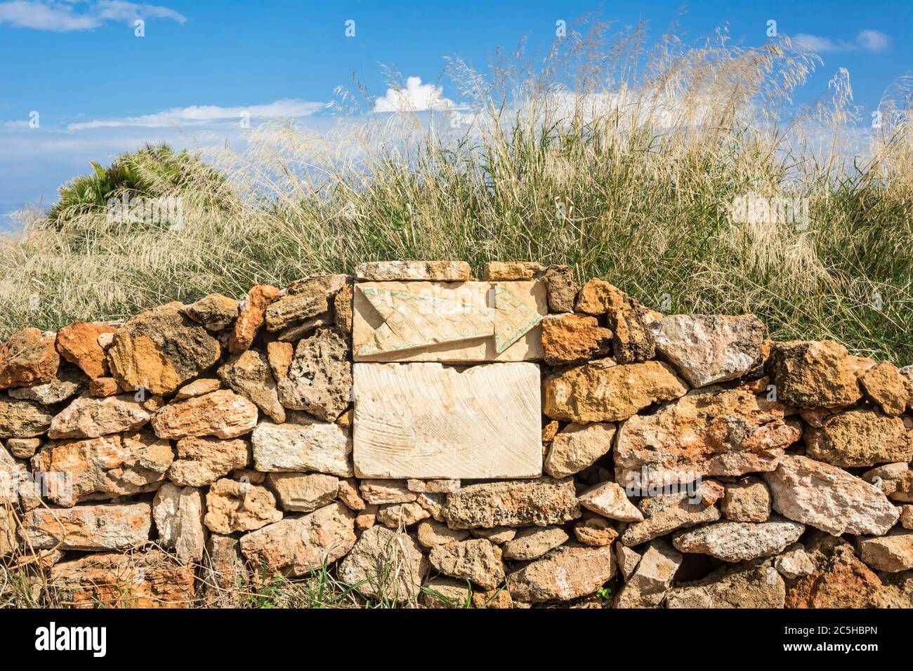 Trail sign in stone wall in scenic Mediterranean landscape Stock Photo ...
