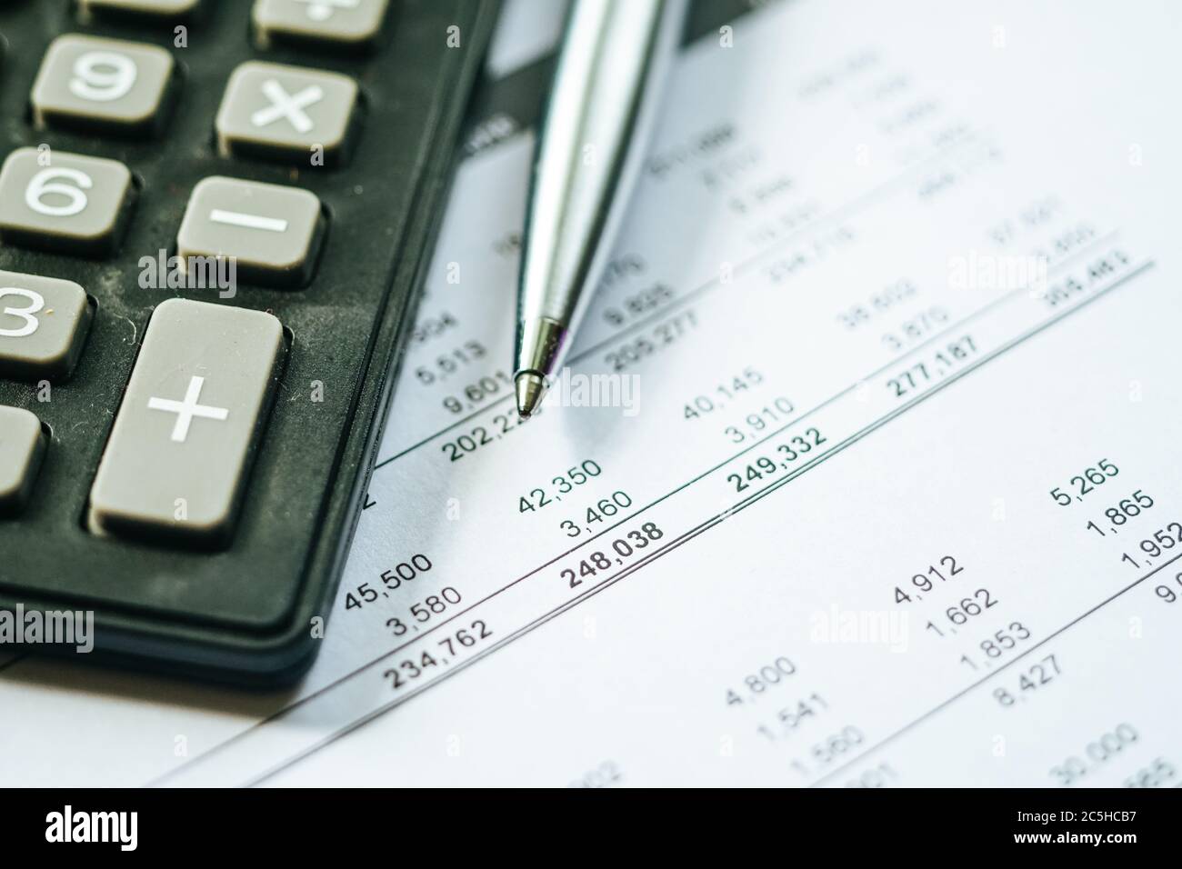 Financial calculation numbers chart with pen, calculator, glass and ...