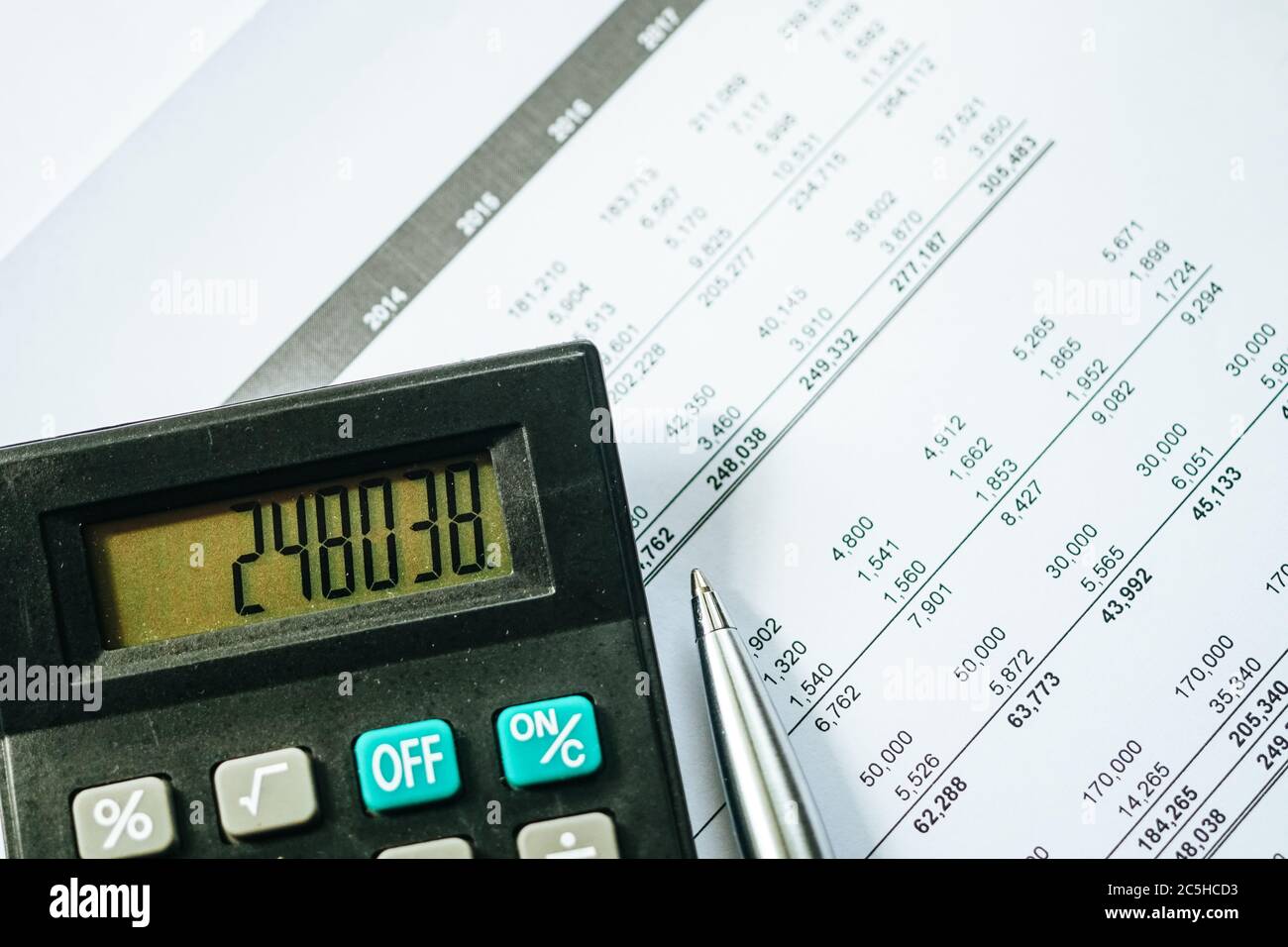 Financial calculation numbers chart with pen, calculator, glass and ...