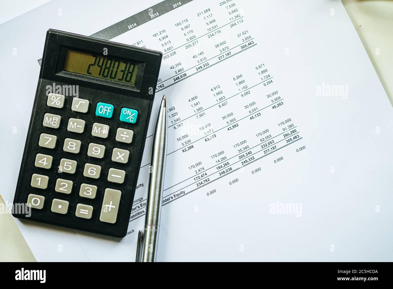 Financial calculation numbers chart with pen, calculator, glass and ...