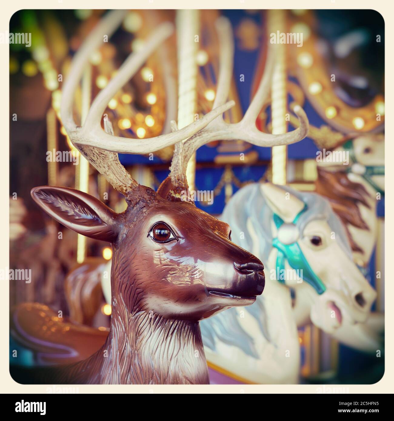 A Christmas reindeer on a carousel ride. Processed and filtered to look ...
