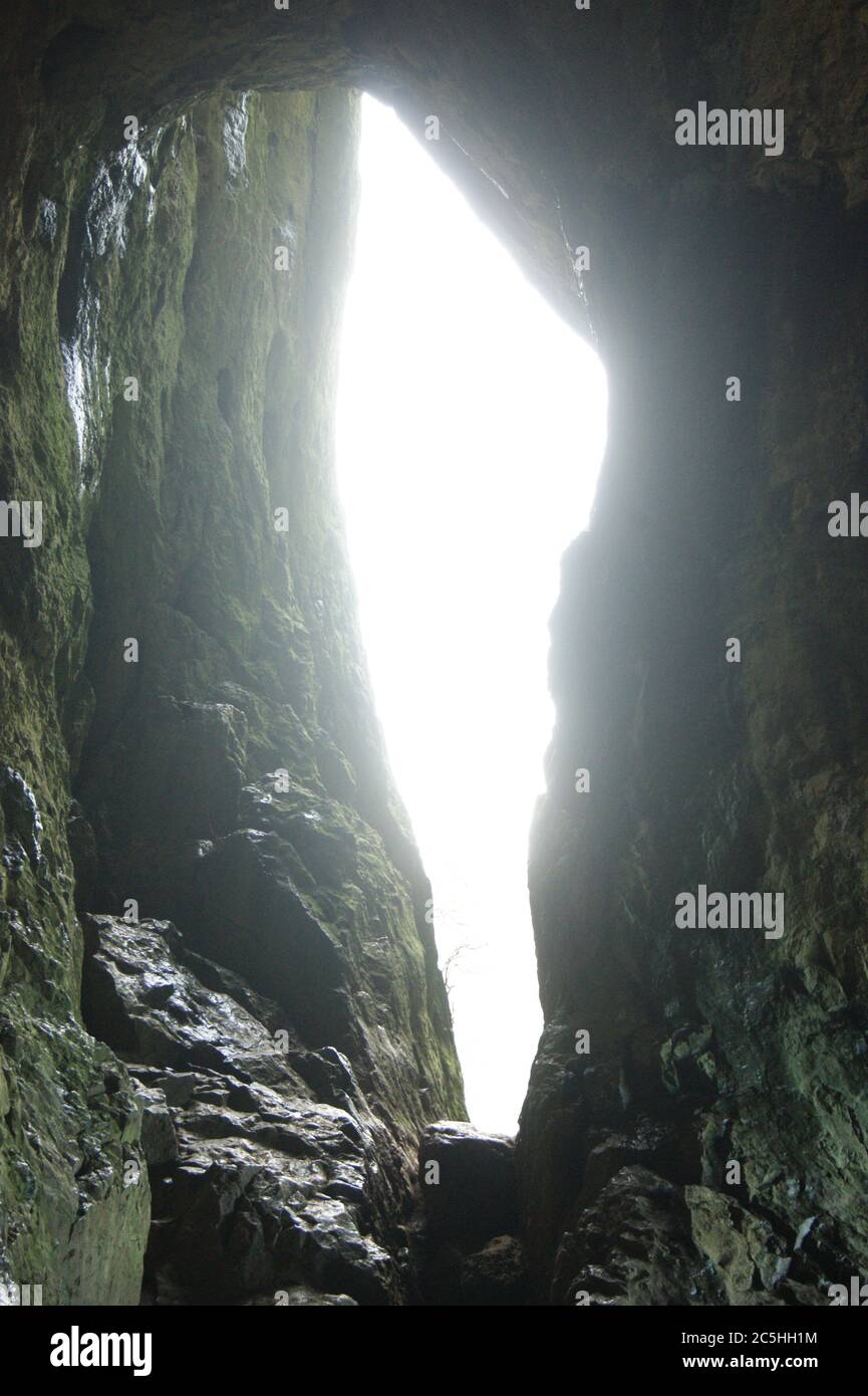 Light shining through crack in a cave, Thor's cave in the peak district ...